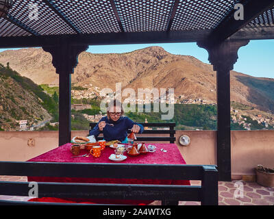 Caucasian blonde girl hlaving typical moroccan breakfast with amlu and ...