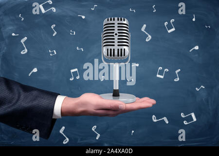 Retro microphone with music notes on color background Stock Photo - Alamy