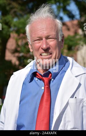 Funny professor at school. Teacher smiling in classroom Stock Photo - Alamy