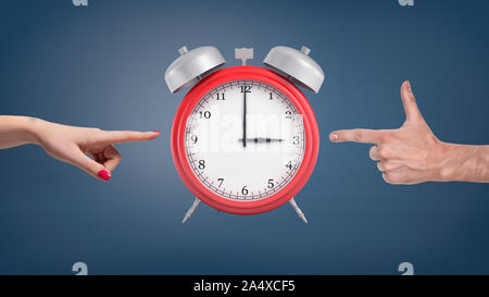 Female hands pointing at alarm clock on lilac background Stock Photo ...