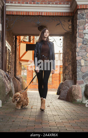 Woman walks with a cocker spaniel Stock Photo - Alamy