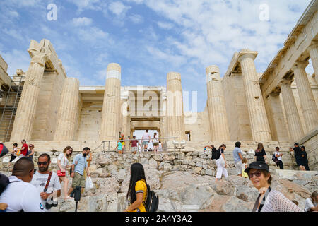 A crowd of tourists around the Acropolis of Athens Unesco heritage with ...