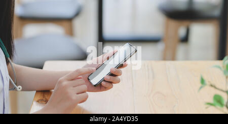 stressed female doctor holding smartphone Stock Photo - Alamy