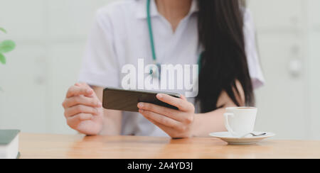 stressed female doctor holding smartphone Stock Photo - Alamy