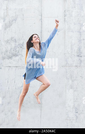 crazy happiness for beautiful woman jumping at home for great joy after ...