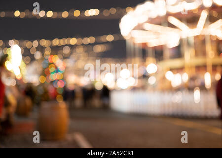 Carousel with burning lights in evening, defocused photo Stock Photo ...
