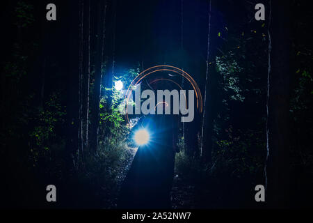 Man who is wearing wizard robes and casting glow spell with his magic ...