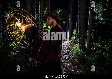 Halloween concept. Powerful Male witch or wizard with blue cold ...
