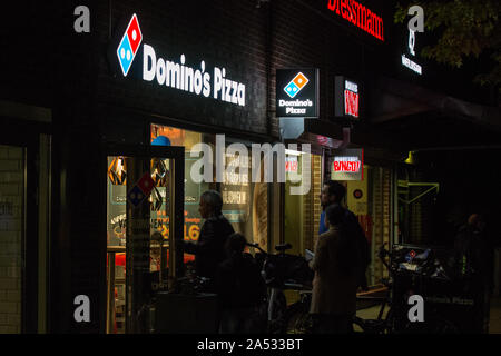 People outside an American multinational pizza restaurant chain Domino ...