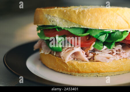 Whole turkey club sandwich with avocado and bacon on freshly baked ...