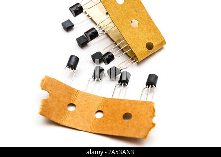 Stack of low power transistors in package TO-92 on a white background ...