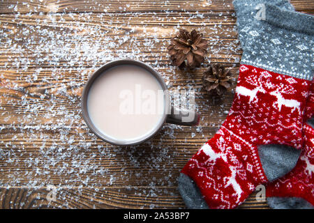 Red Christmas socks with deer and ornament on white wooden background ...