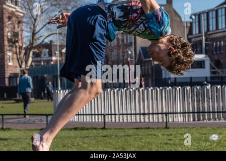 Amsterdam, Holland, February 25 2019 street flipping boy on the grass ...