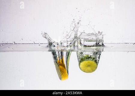 Lime slice in the water with bubbles isolated on white background Stock Photo - Alamy