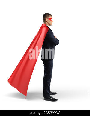 Strong man hero with red mantle standing against blue background ...