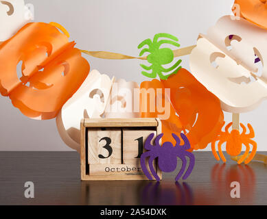 wooden calendar of cubes, garland of pumpkins and spiders, Halloween ...