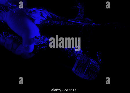 Microphone Sinking - underwater mic. Holding a microphone in hand under ...