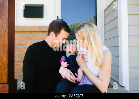 Yawning baby portrait on red silk shawl background Stock Photo - Alamy