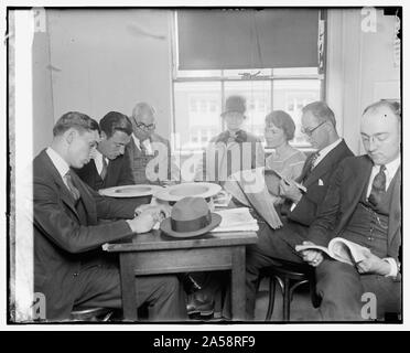 A group of people seated around a table in a room decorated with ...