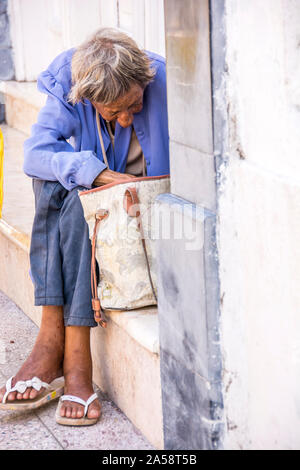 Woman rummaging through purse Stock Photo - Alamy