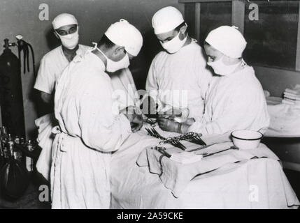 A surgeon, anesthetist, technician, and nurse participate in the ...