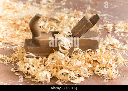 Joinery – old wooden plane, wood polishing tool in a workshop of the ...