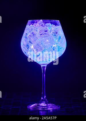 Gin tonic under blacklight (UV) illumination. Glow in the dark drink ...