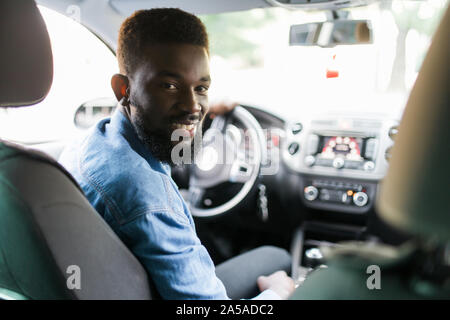 Happy black guy driving car, going to job Stock Photo - Alamy