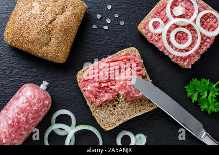 german sandwich mettbrotchen, bun and raw meat with onion and parsley ...