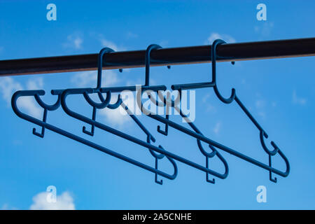 The hanger blue on the rails, stainless steel Stock Photo - Alamy