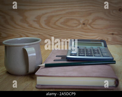 Open notebook and color pencil, cup of black tea on purple check ...