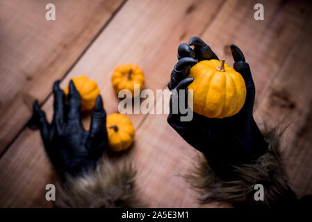 Happy Halloween. Werewolf or zombie hands painting scary pumpkin for ...