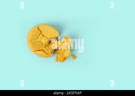 Crushed yellow macaroon on pastel blue background with copy space Stock ...