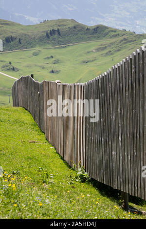Wooden fence on green hill Stock Photo - Alamy