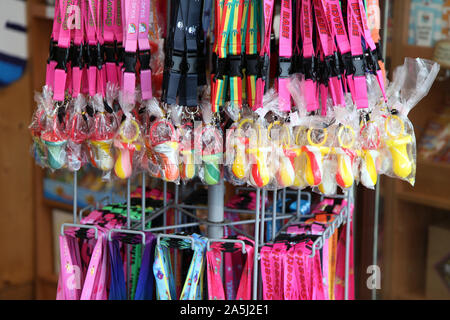 A group of candy rock dummies on ribbons hanging in sweet shop store ...