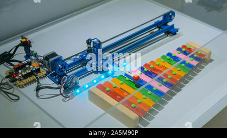 Robot playing on colorful xylophone at technology exhibition. Future ...