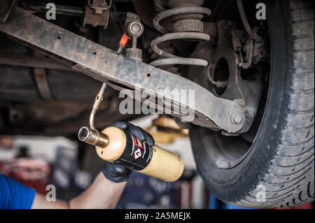 Male mechanic checking welding torch Stock Photo - Alamy