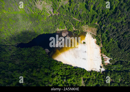 Abandoned industrial mining area. Drone view of opencast mine filled ...