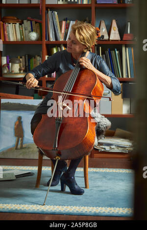 Woman playing cello in front of tree at park Stock Photo - Alamy
