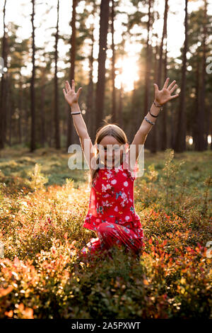 Girl with arms raised outdoors Stock Photo - Alamy