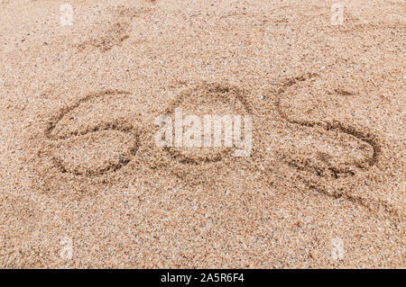 S.O.S written in the sand with a finger or stick Stock Photo - Alamy