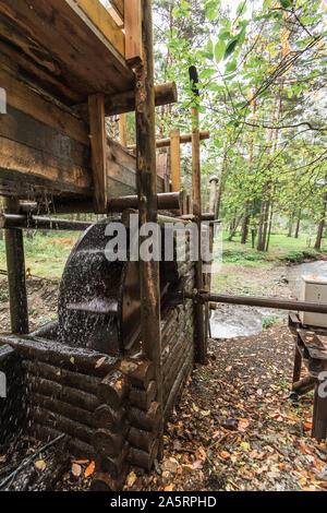 Wooden water mill. A hydraulic structure using hydropower from a water ...