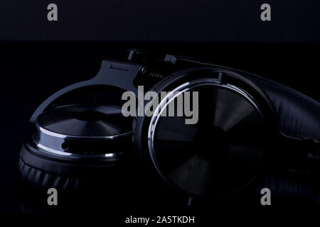 black headphones dark photographed glossy Stock Photo - Alamy