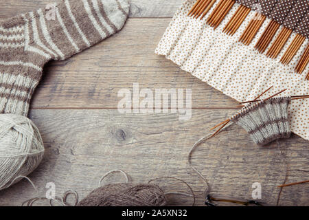 The process of knitting sock with circular bamboo knitting needles, on ...