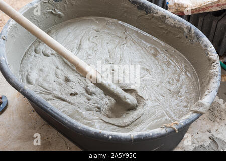 cement mix concrete is compacted sand by spade for construction Stock ...