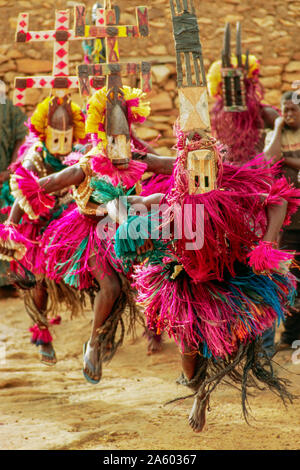 Dogon dancers performing the Dama ritual dance wearing Kanaga masks ...