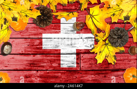 Switzerland flag on autumn wooden background with leaves and good place ...