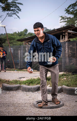 Men participate in a traditional ball-throwing game at a Hmong festival ...