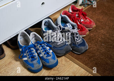 A collection of trainers in a home hallway Stock Photo - Alamy