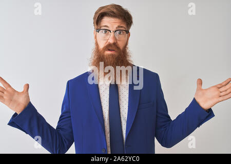 Young redhead irish businessman wearing suit and glasses over isolated ...